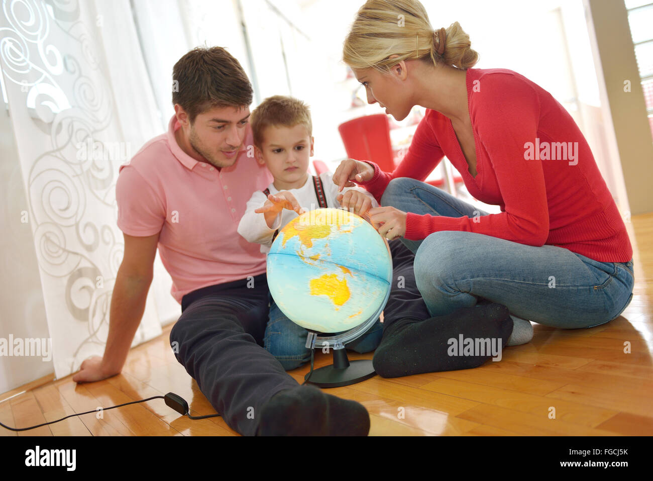 family have fun with globe Stock Photo - Alamy