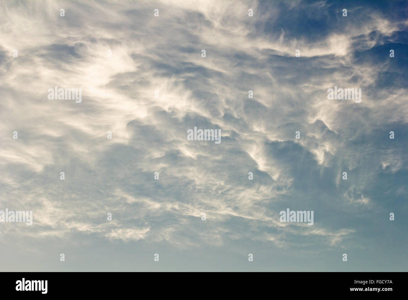 Layered clouds in sky slightly illuminated by sun Stock Photo - Alamy