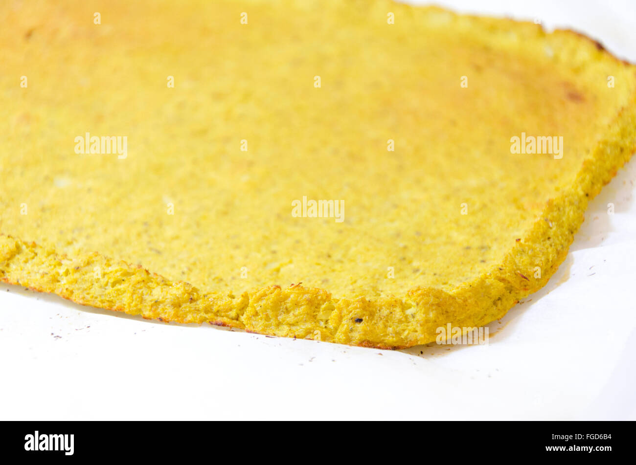 Rectangular cauliflower pizza crust with selective focus on edge. A ...