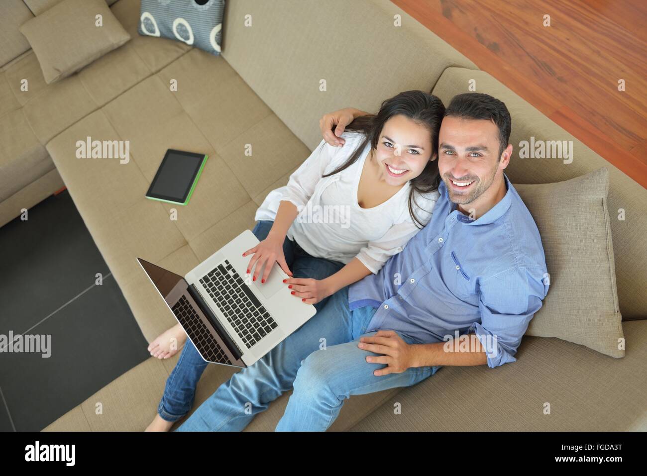 young couple using laptop at home Stock Photo - Alamy
