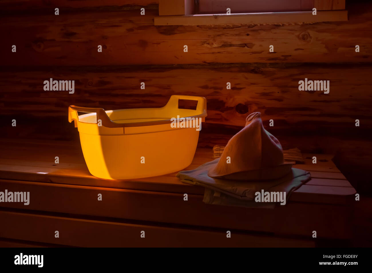 Yellow plastic basin in sauna lit by sun Stock Photo - Alamy
