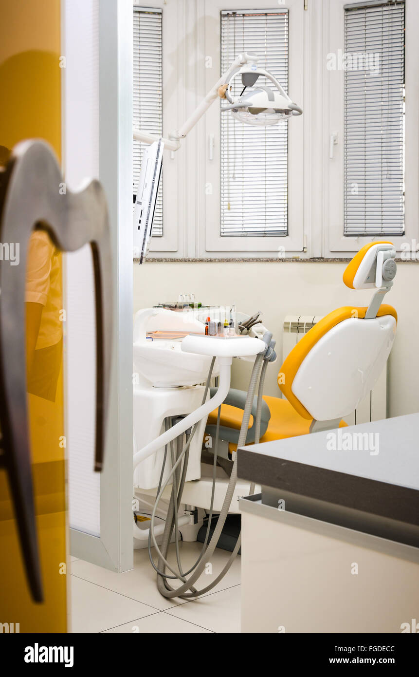 Dentist office seen through the open door, with handle in the shape of ...