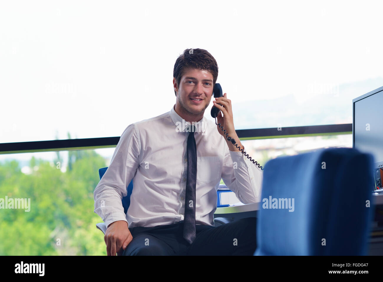 happy young business man at office Stock Photo - Alamy