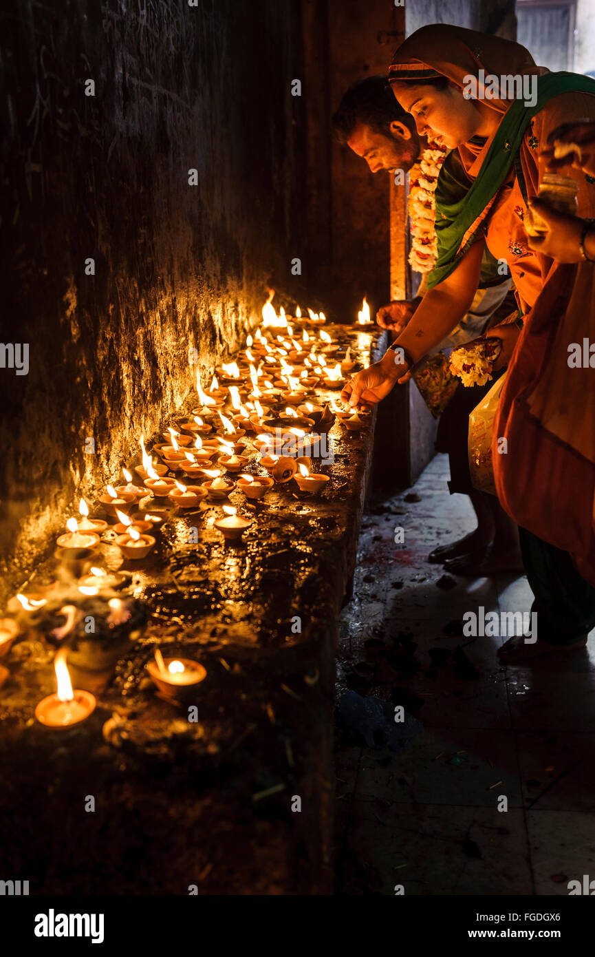 People lighting candles to honour the gods during Holi festival Stock ...