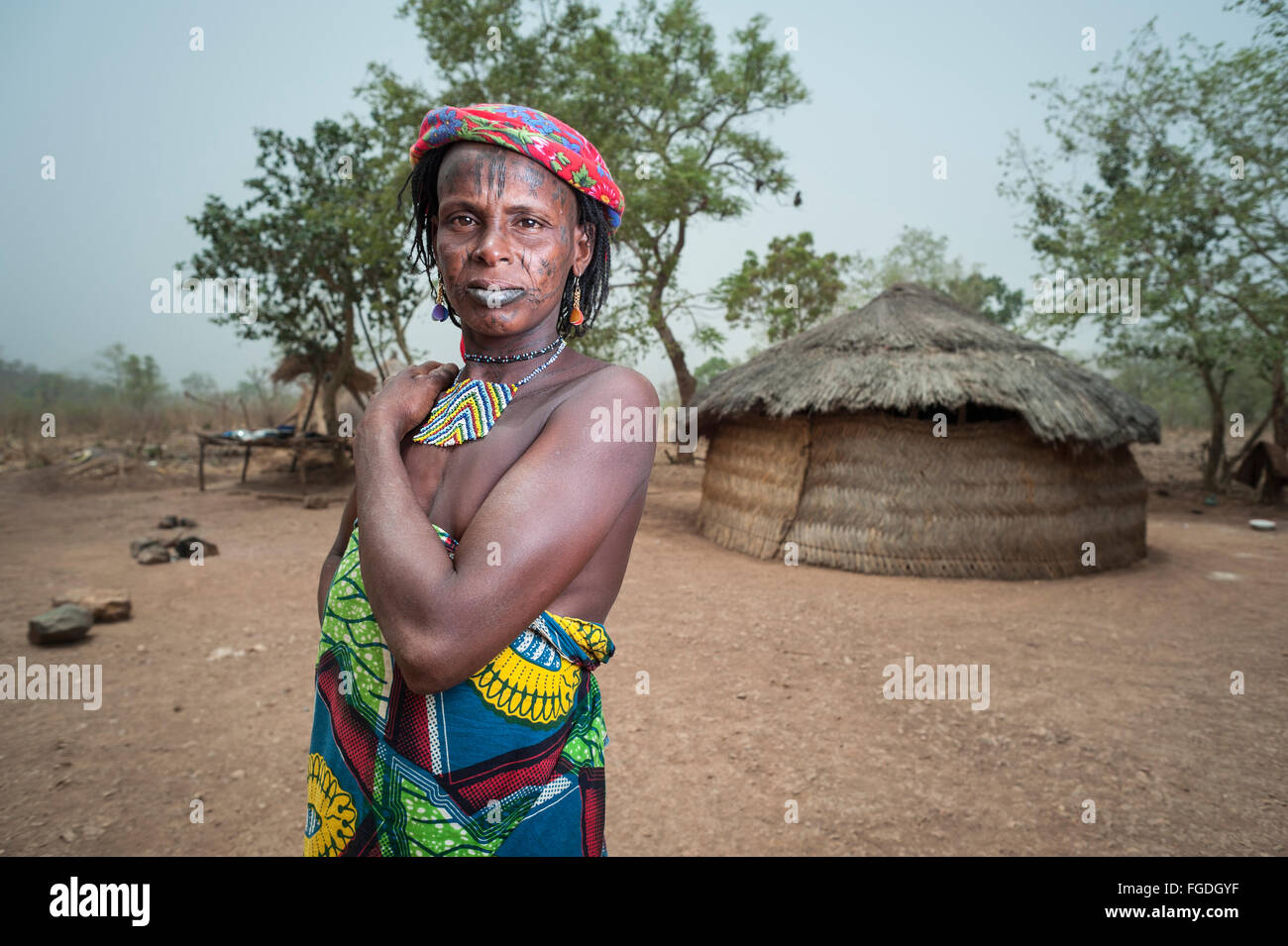 Portrait of a Mbororo woman with scars on her face outside her hut ...