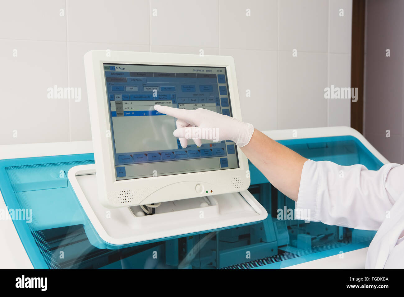 Lab tech loading samples into a chemistry analyzer Stock Photo - Alamy