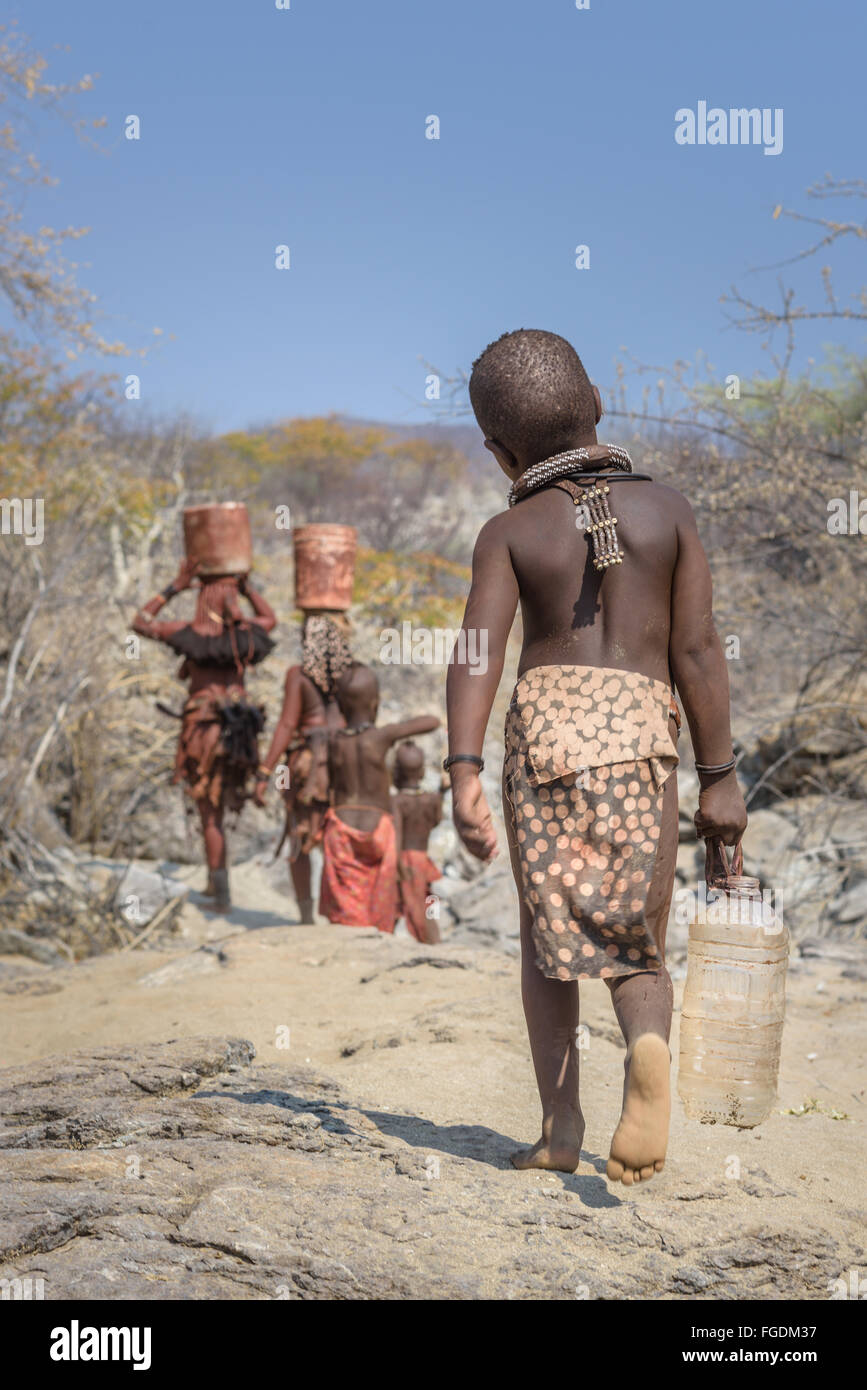 Kids from the himba tribe fetching water from a well nearby their ...