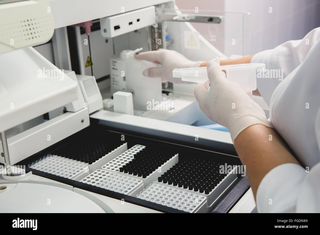 Researcher loading samples analyzer hi-res stock photography and images ...