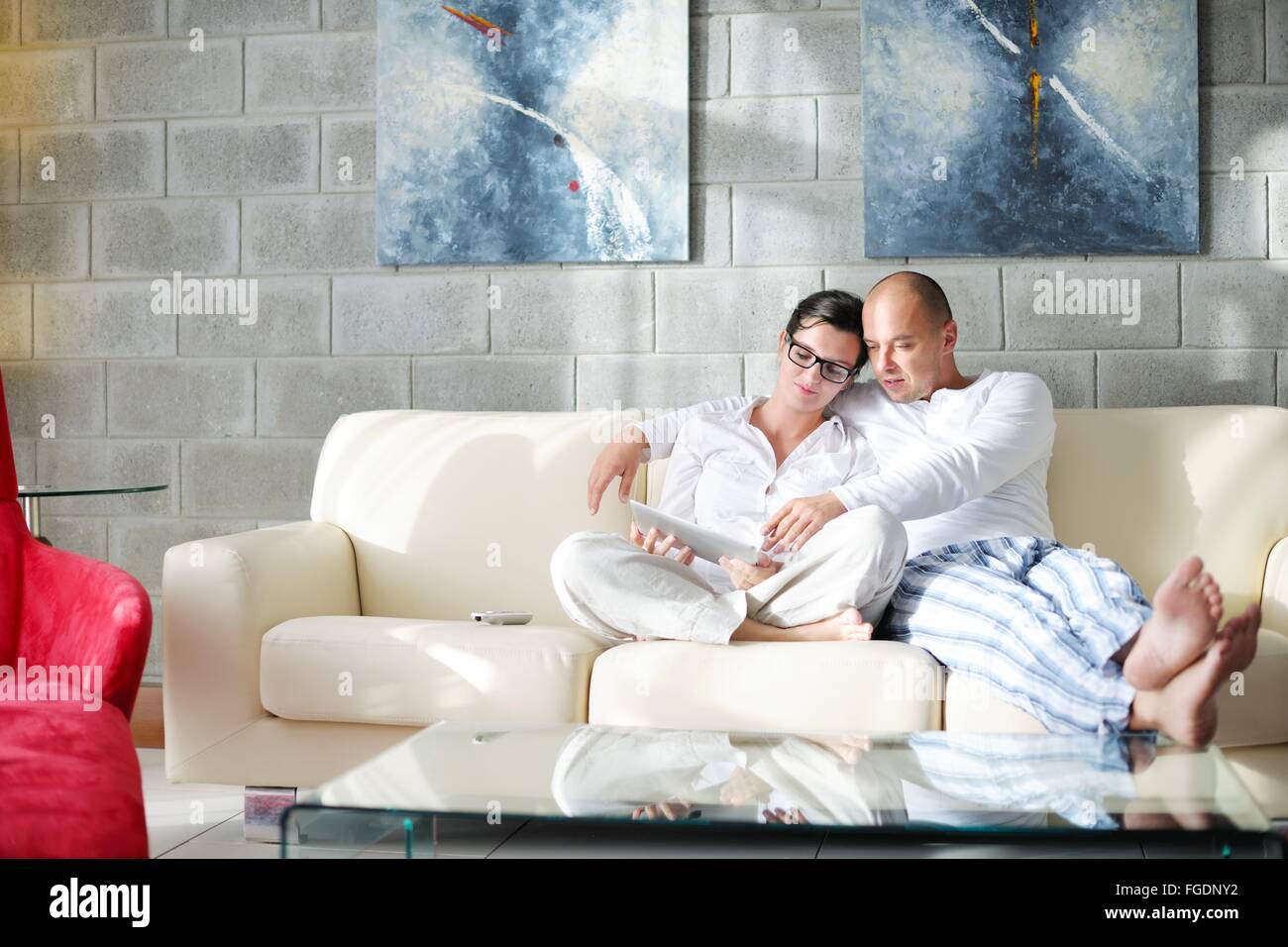 young couple using tablet computer at home Stock Photo - Alamy