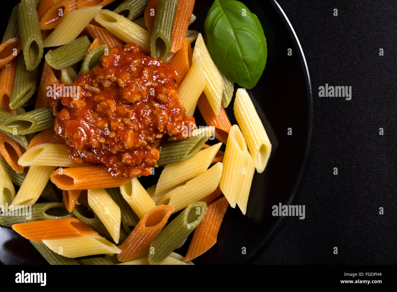 Penne rigate pasta with a beef, pork and tomato ragu Stock Photo - Alamy