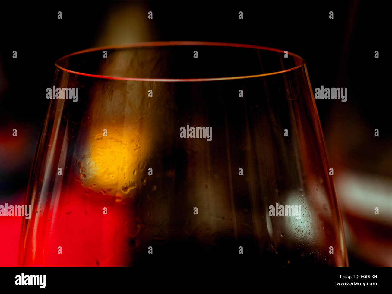 Wine glass in dim light with different shades of colors Stock Photo - Alamy