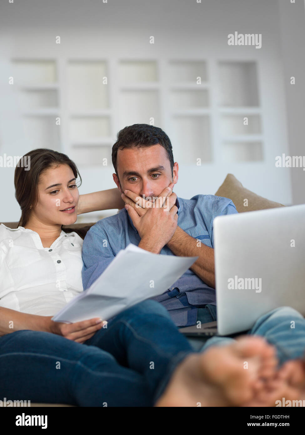 relaxed young couple working on laptop computer at home Stock Photo - Alamy
