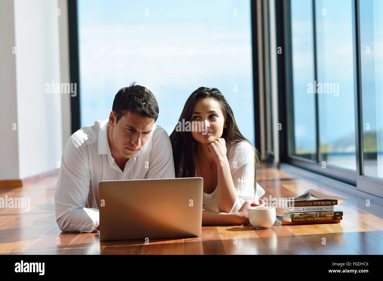 relaxed young couple working on laptop computer at home Stock Photo - Alamy