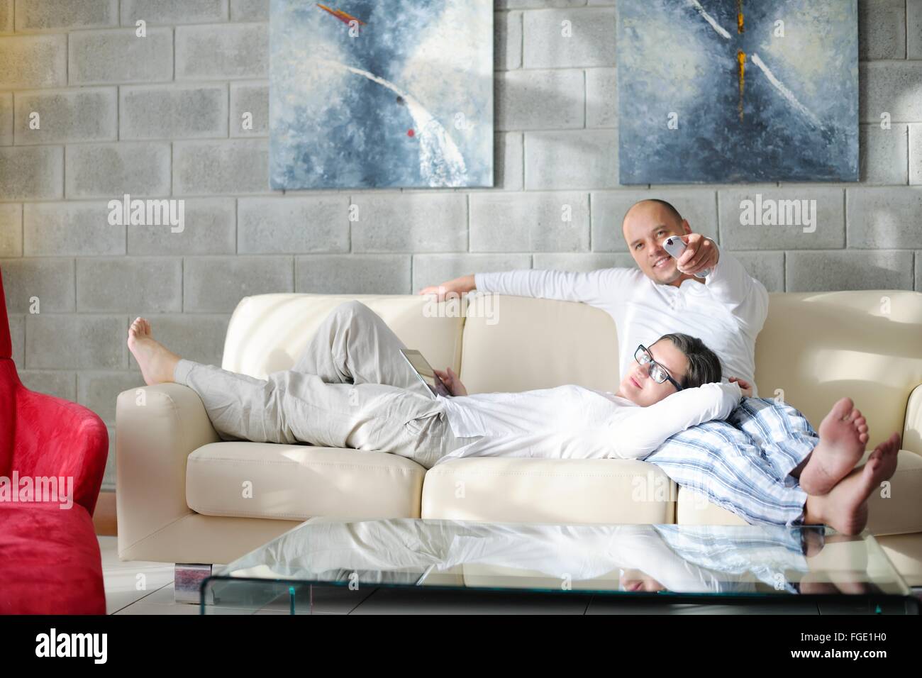 young couple using tablet computer at home Stock Photo - Alamy