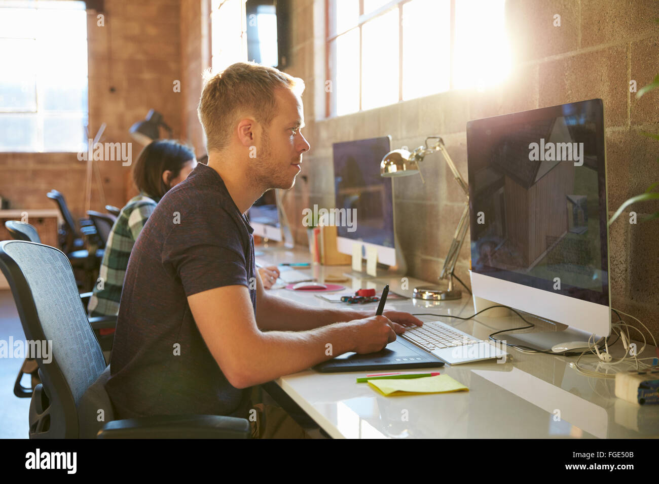 Designers Working At Desks In Modern Office Stock Photo - Alamy