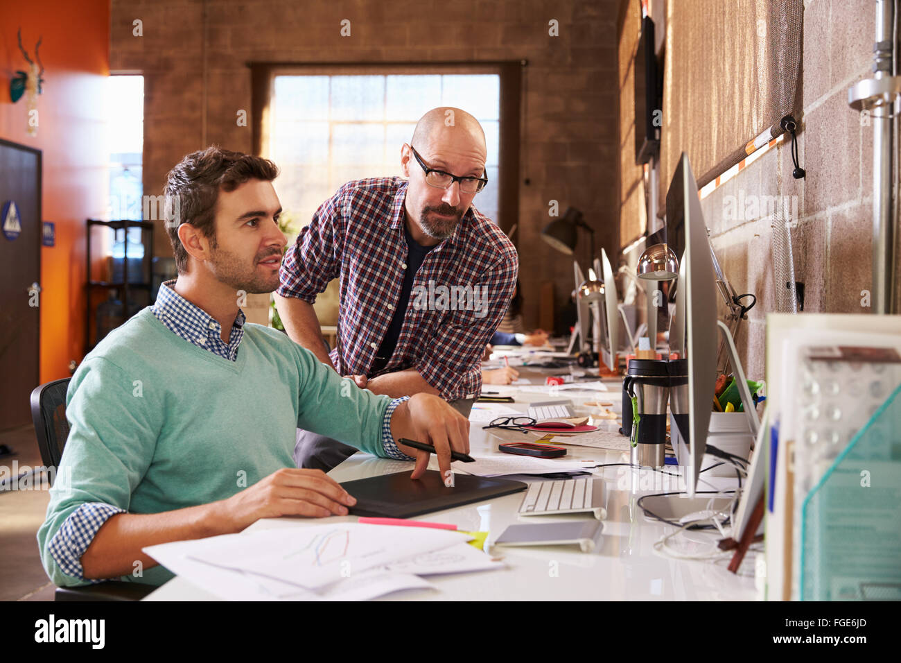 Designers Working Together At Desks In Modern Office Stock Photo - Alamy
