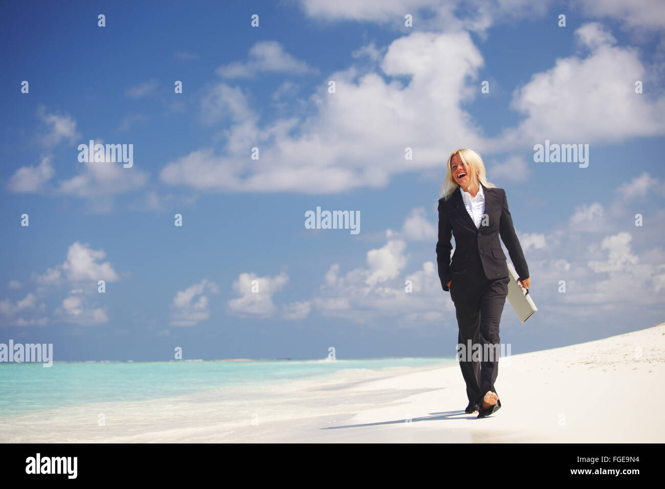 business woman with briefcase walking on the desolate ocean coast Stock ...