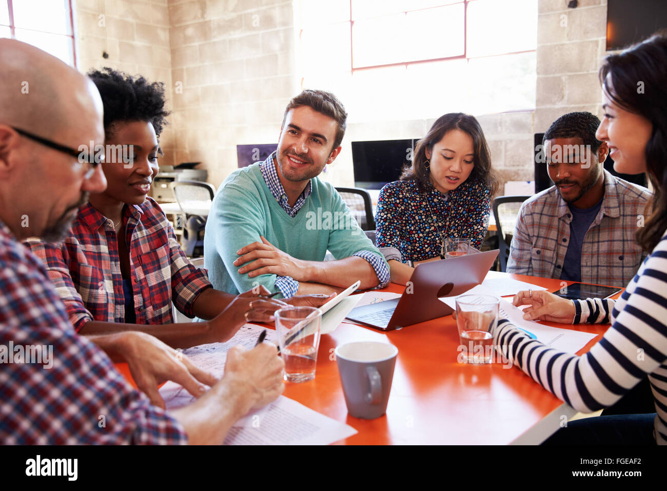 Group designers meeting around table hi-res stock photography and ...
