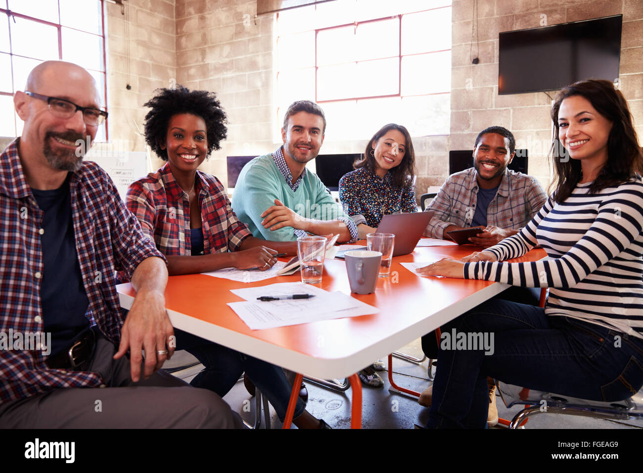 Group Of Designers Having Meeting Around Table In Office Stock Photo ...