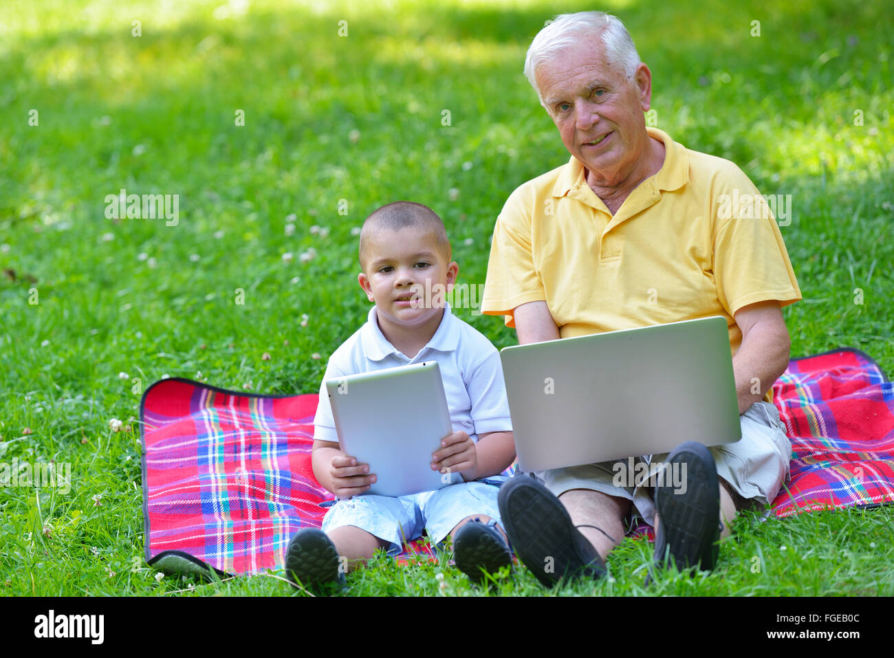grandfather and child using laptop Stock Photo - Alamy