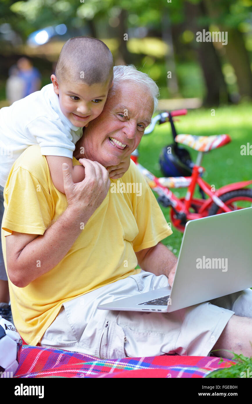 grandfather and child using laptop Stock Photo - Alamy