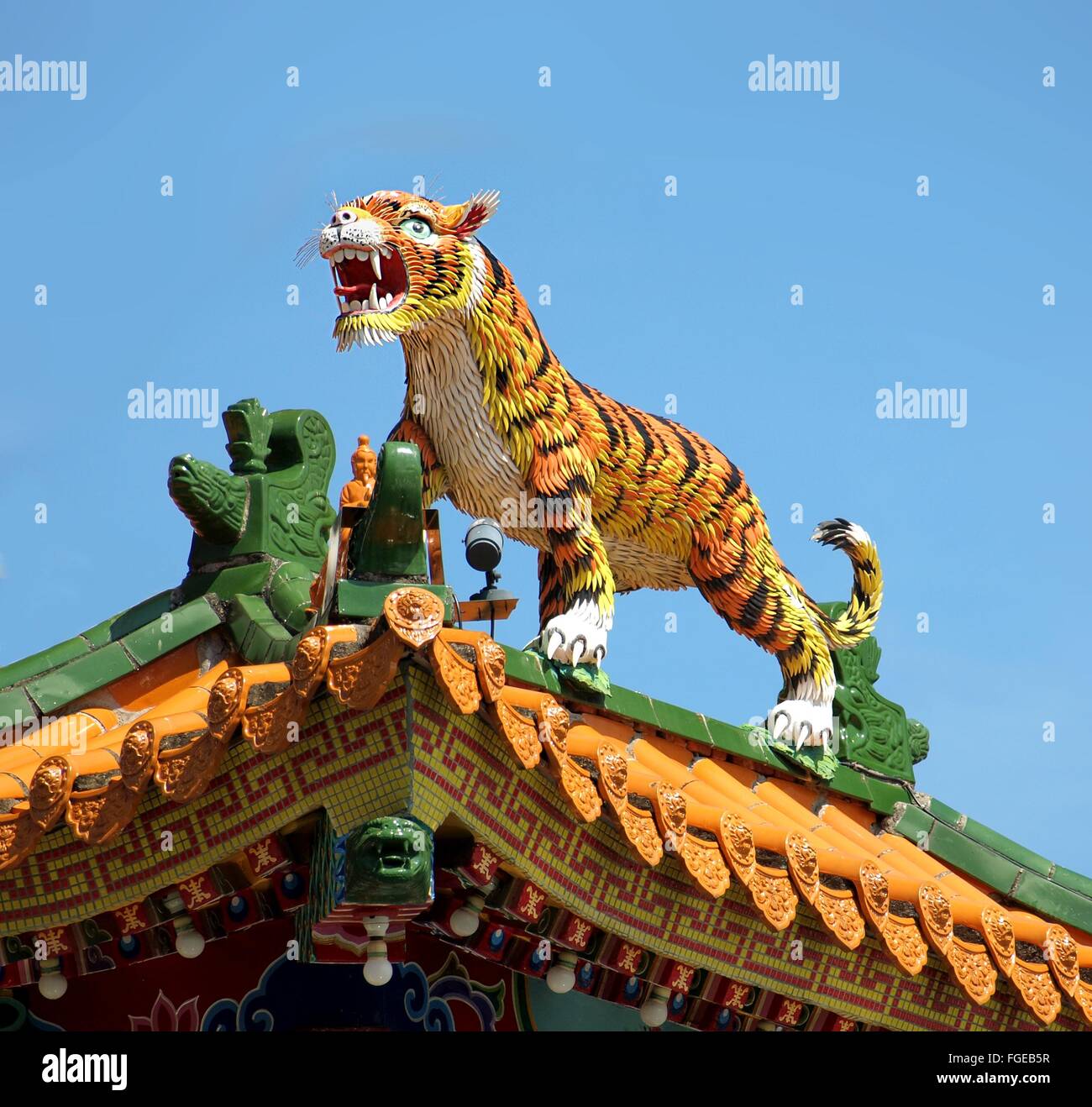 A ceramic sculpture of a fierce tiger on a traditional Chinese temple ...