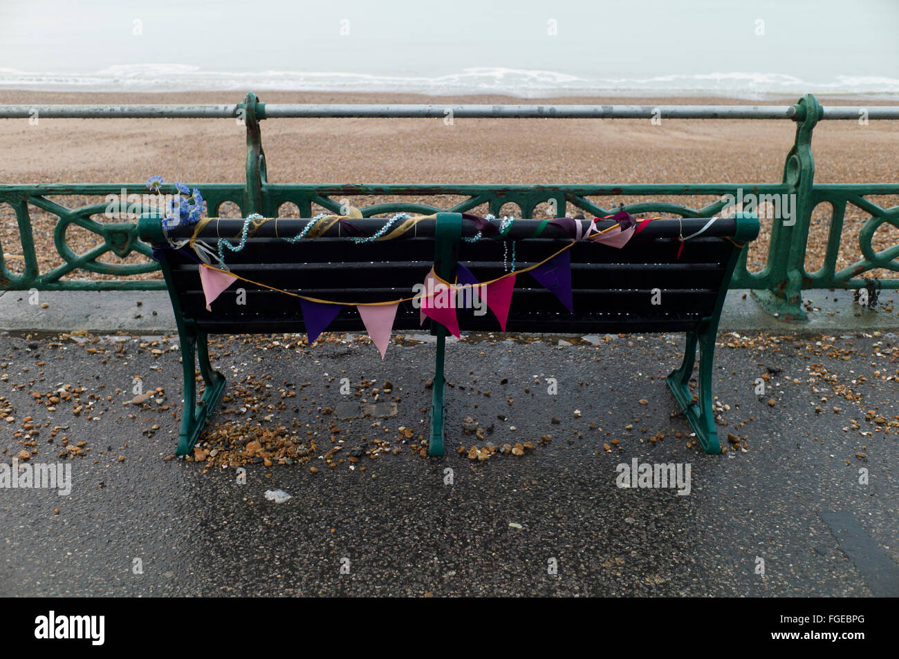 Seaside memorial bench in the rain Stock Photo - Alamy