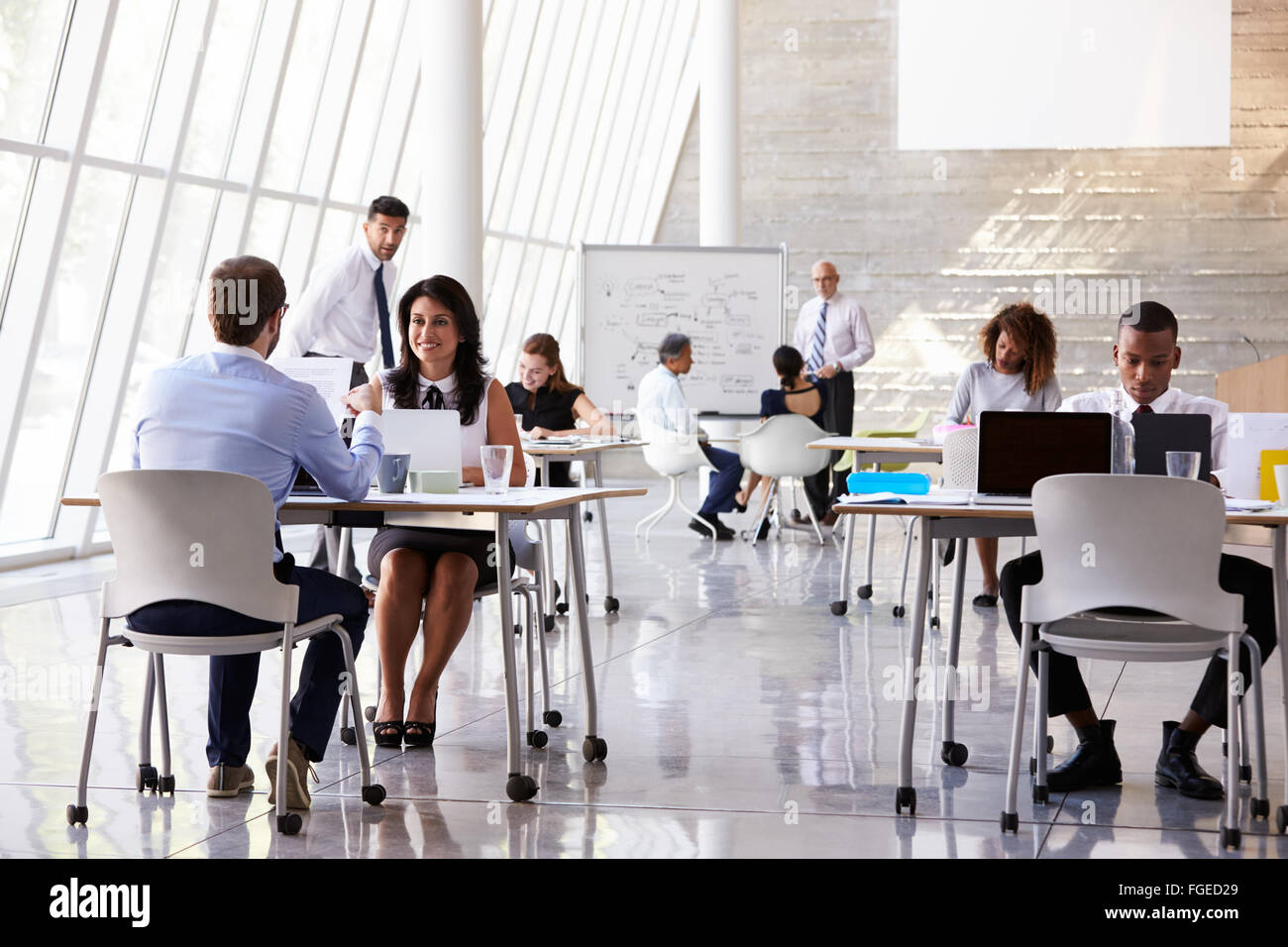 Businesspeople Working At Desks In Modern Office Stock Photo - Alamy
