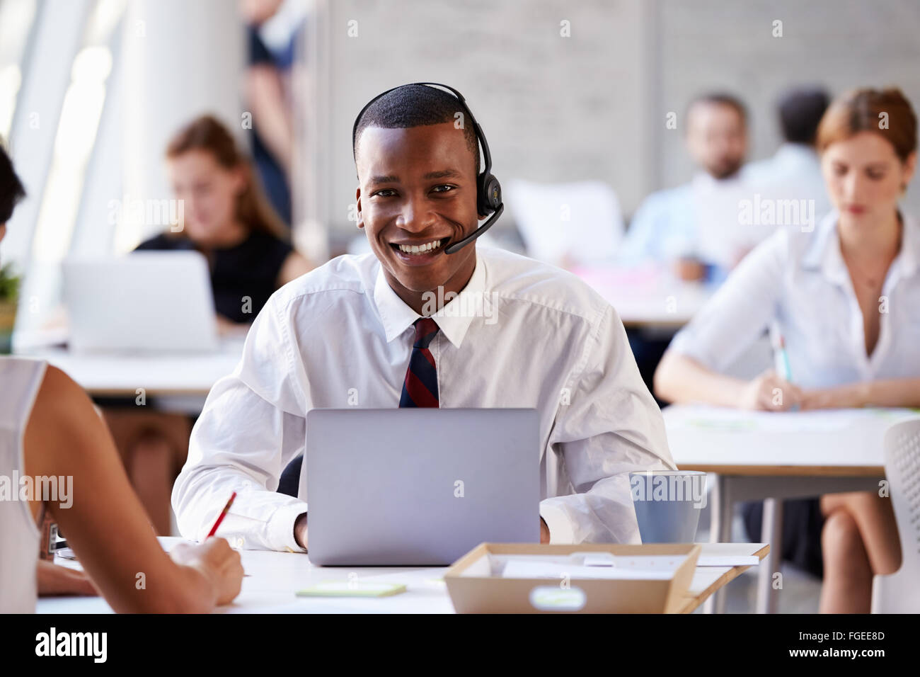 Businessman Using Laptop In Customer Service Department Stock Photo - Alamy