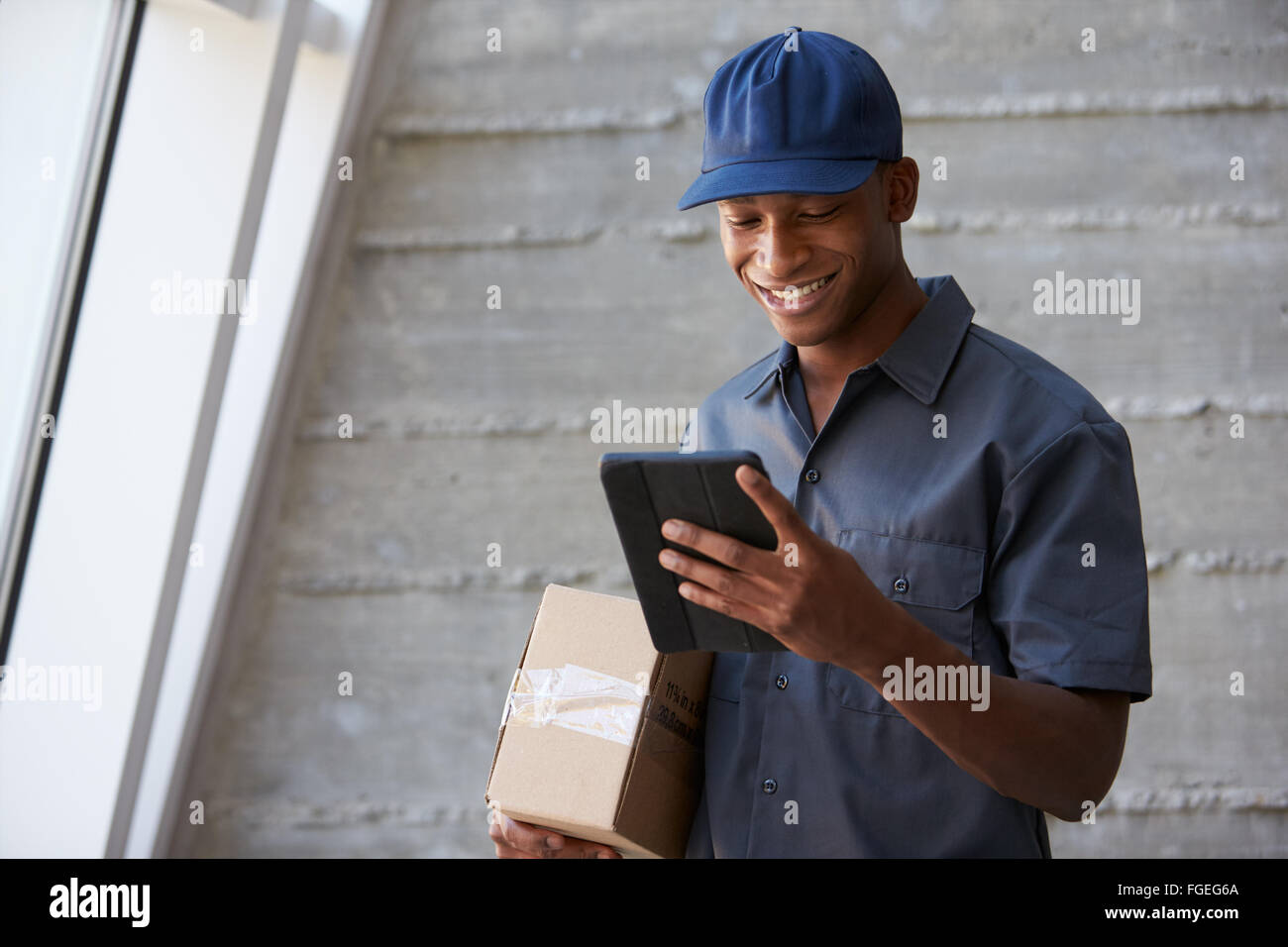 Courier Collecting Package From Office Stock Photo - Alamy