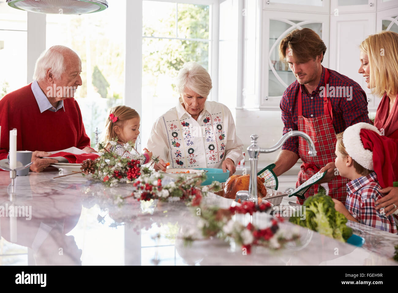 Extended Family Group Preparing Christmas Meal In Kitchen Stock Photo ...