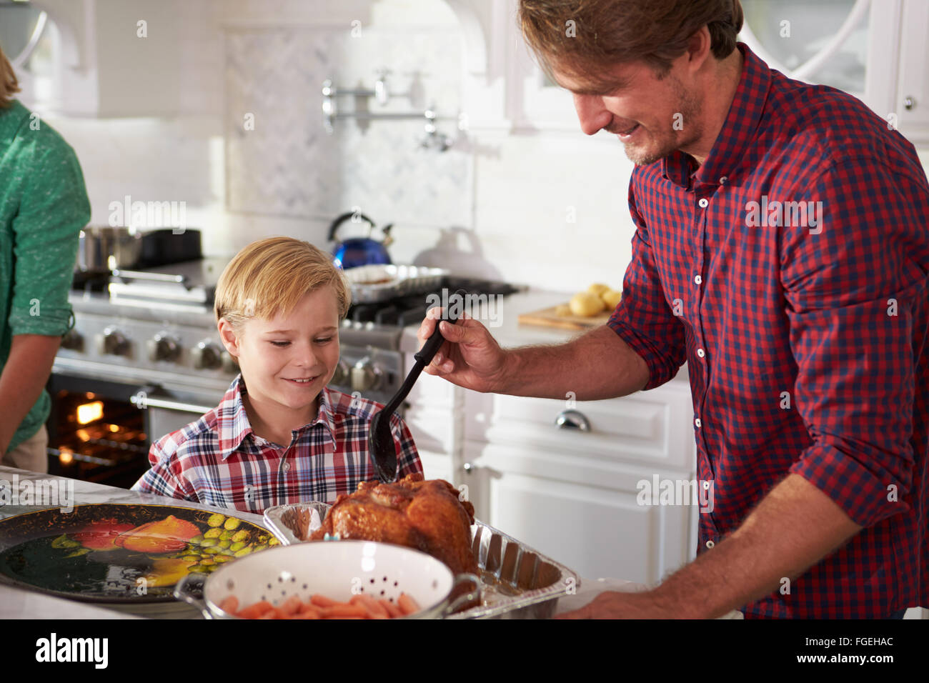 Father And Son Cooking Roast Turkey In Kitchen Together Stock Photo - Alamy