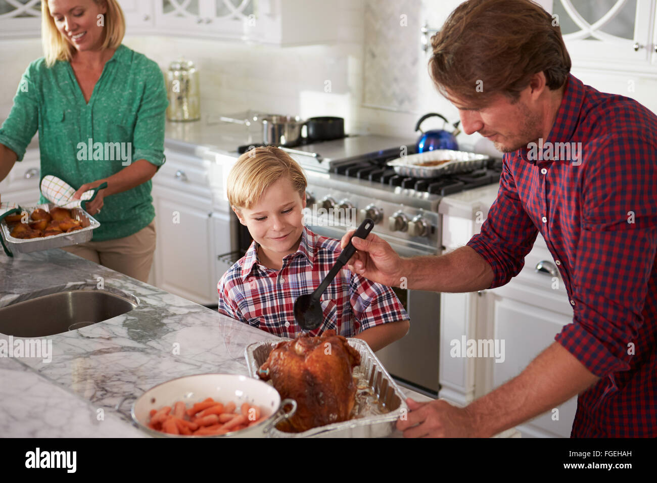 Father And Son Cooking Roast Turkey In Kitchen Together Stock Photo - Alamy