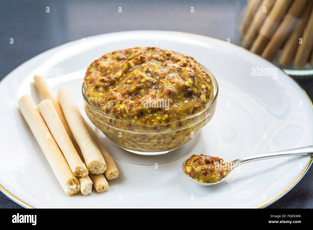 French mustard in a glass bowl on a bone china plate Stock Photo - Alamy