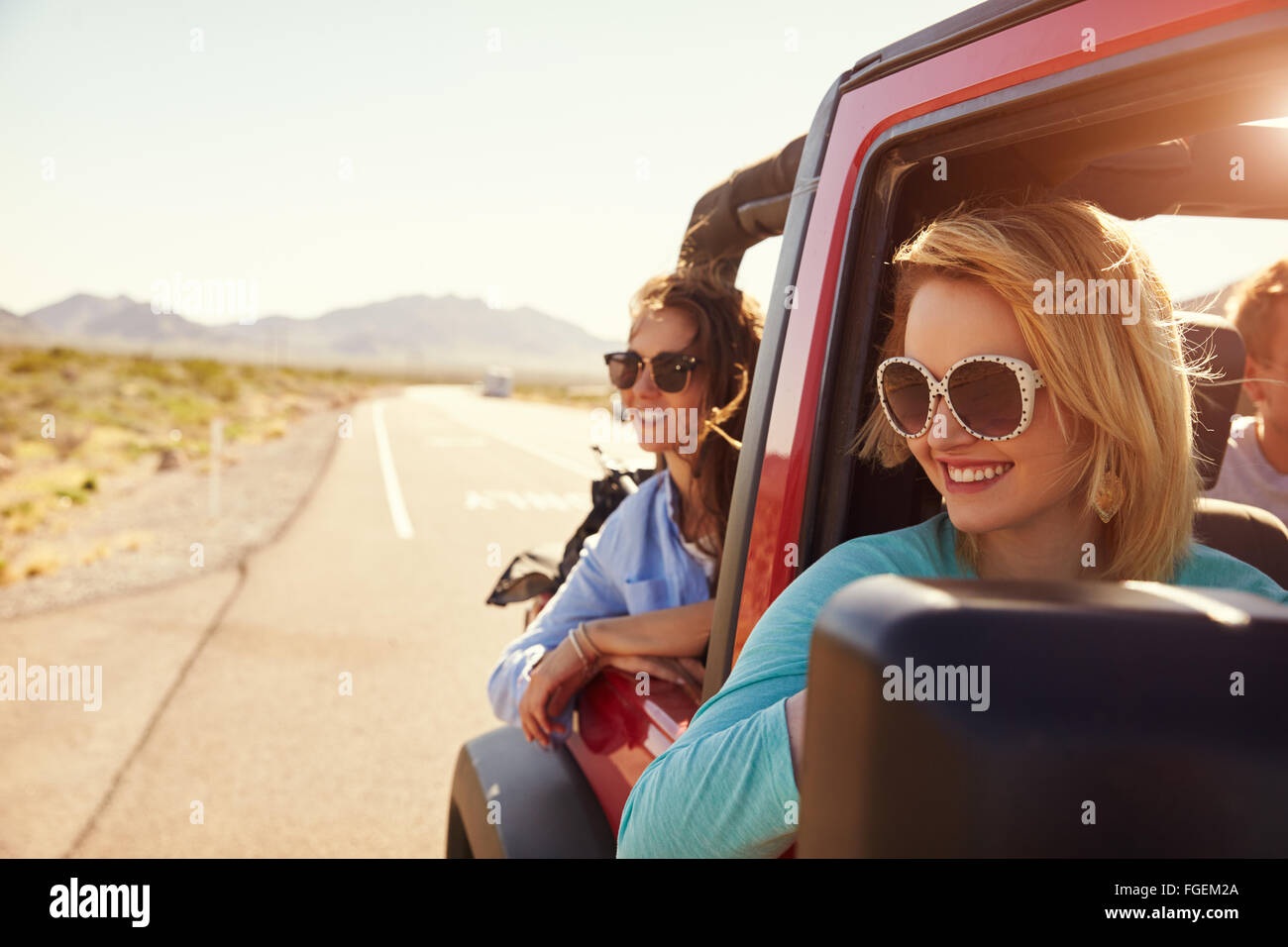 Female Friends On Road Trip In Back Of Convertible Car Stock Photo - Alamy