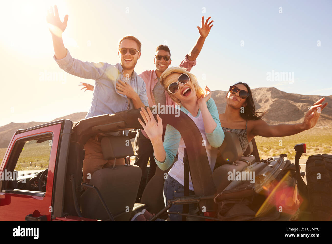Friends On Road Trip Standing In Convertible Car Stock Photo - Alamy