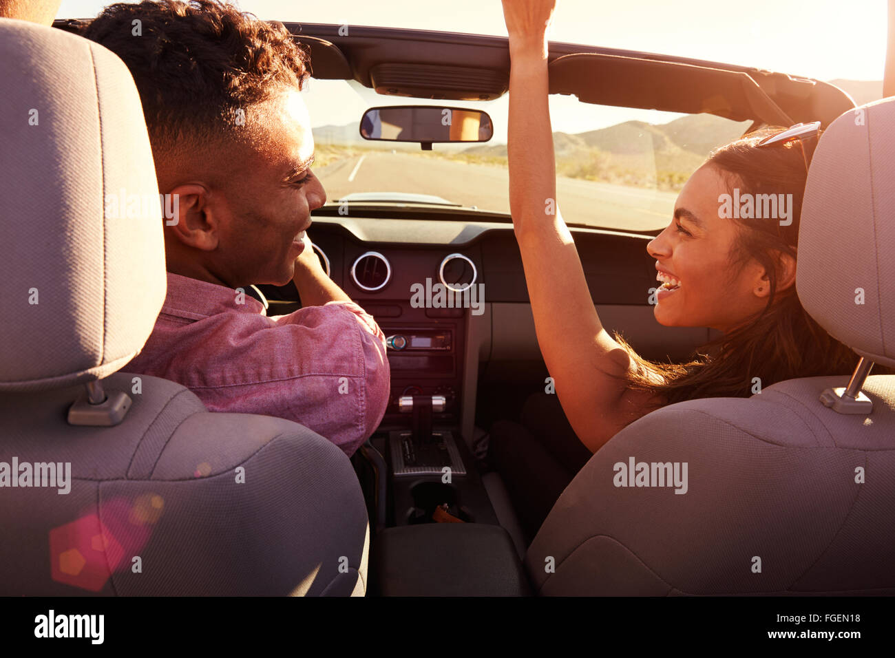 Couple On Road Trip Driving In Convertible Car Stock Photo - Alamy