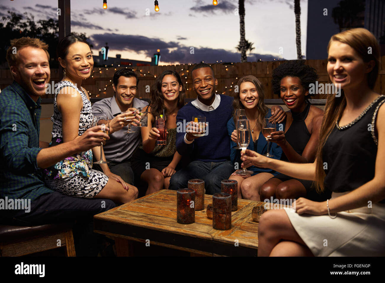 Portrait Of Friends Enjoying Night Out At Rooftop Bar Stock Photo - Alamy