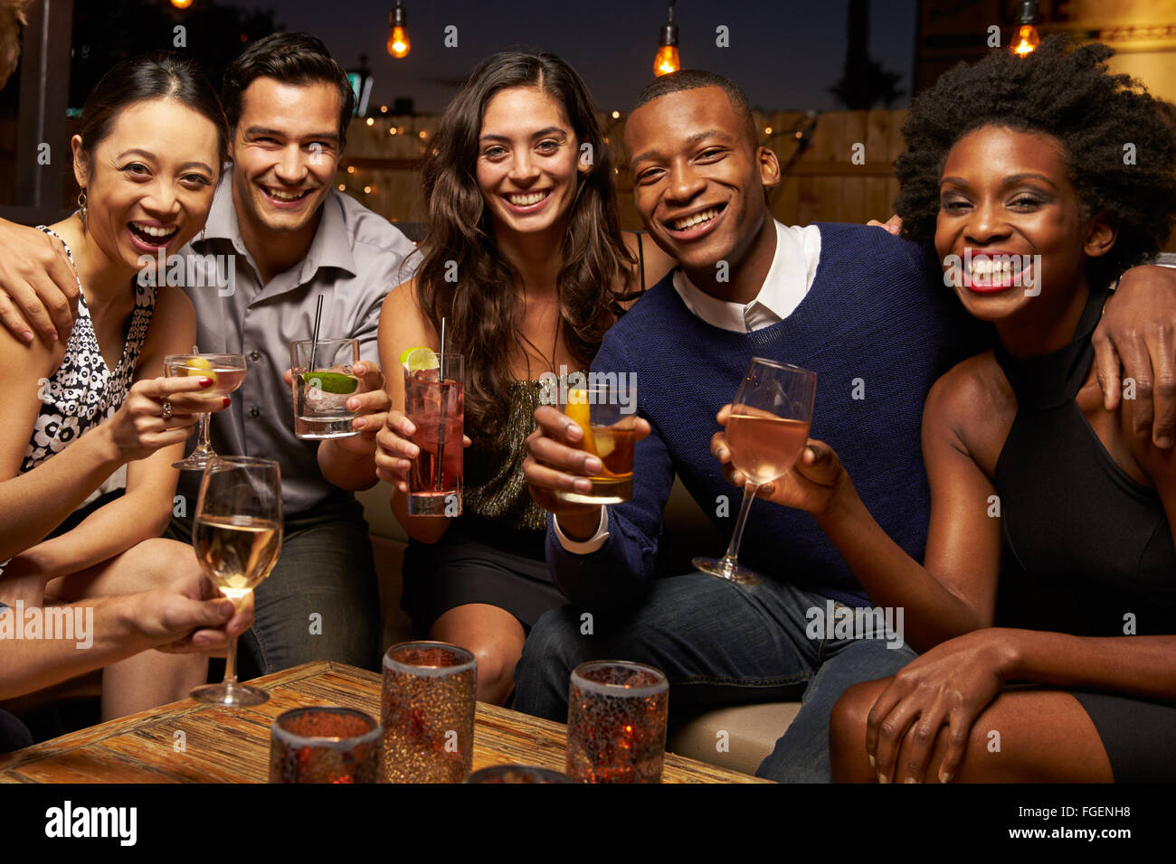 Portrait Of Friends Enjoying Night Out At Rooftop Bar Stock Photo - Alamy