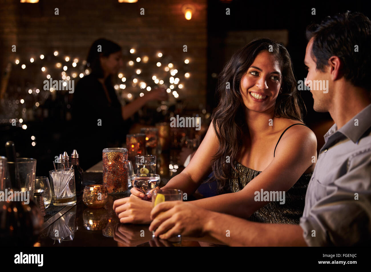 Couple Enjoying Night Out At Cocktail Bar Stock Photo - Alamy