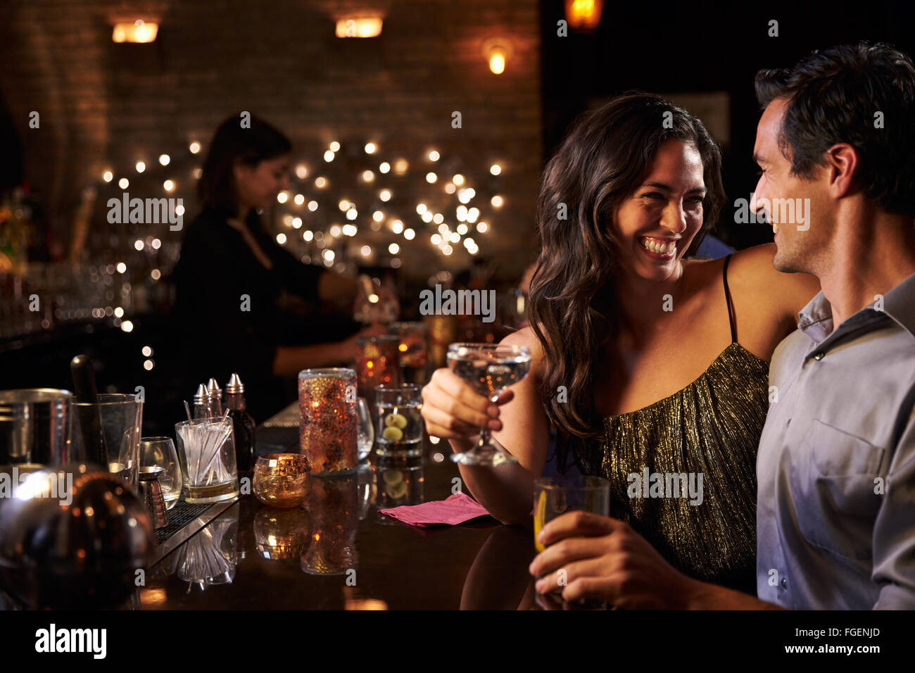 Couple Enjoying Night Out At Cocktail Bar Stock Photo - Alamy