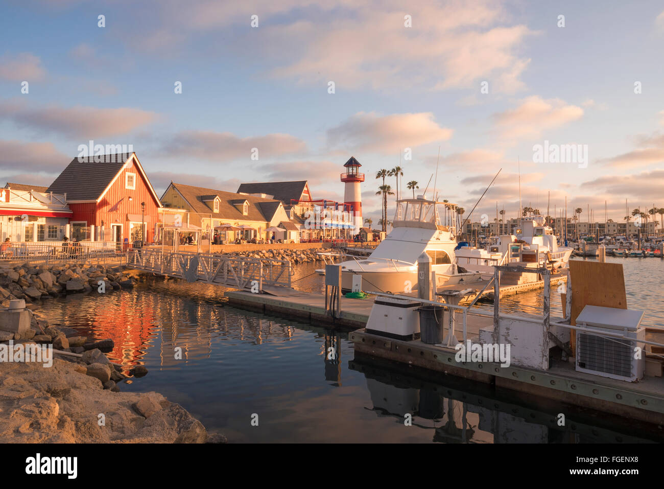 Oceanside harbor, light house, colorful building on wharf. Boats docked ...
