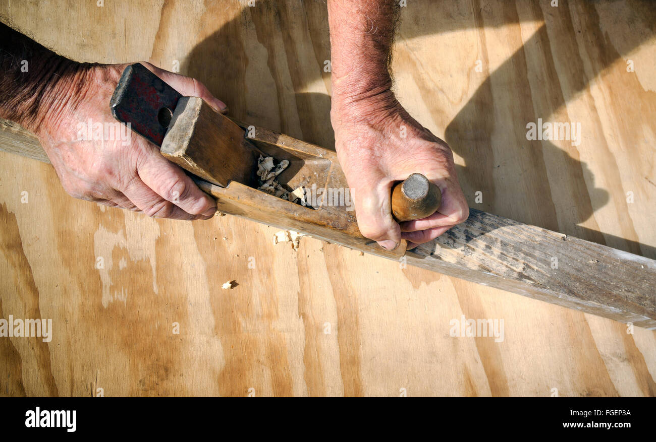 Carpenter's hands working with the old wooden jointer Stock Photo - Alamy