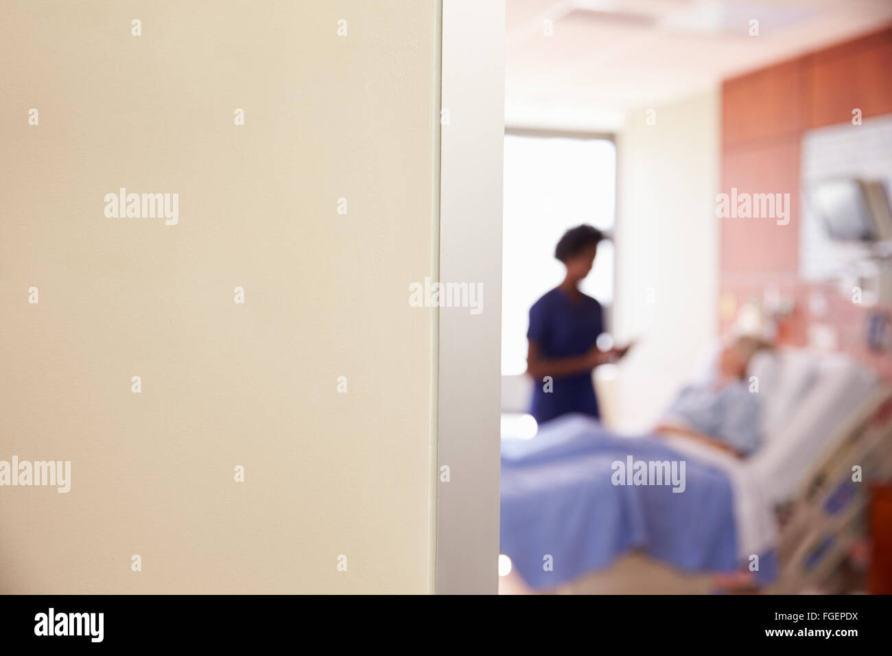 Focus On Hospital Room Sign With Nurse Talking To Patient Stock Photo ...