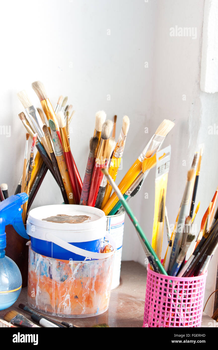 Artists brushes and paint container Stock Photo - Alamy