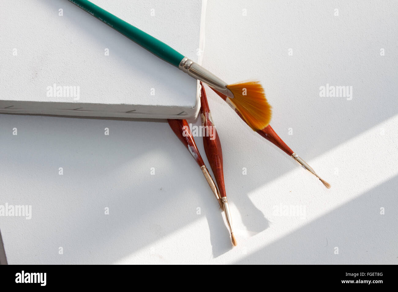 Artists brushes and paint container Stock Photo - Alamy