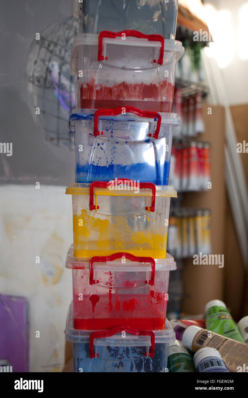 Artists brushes and paint container Stock Photo - Alamy
