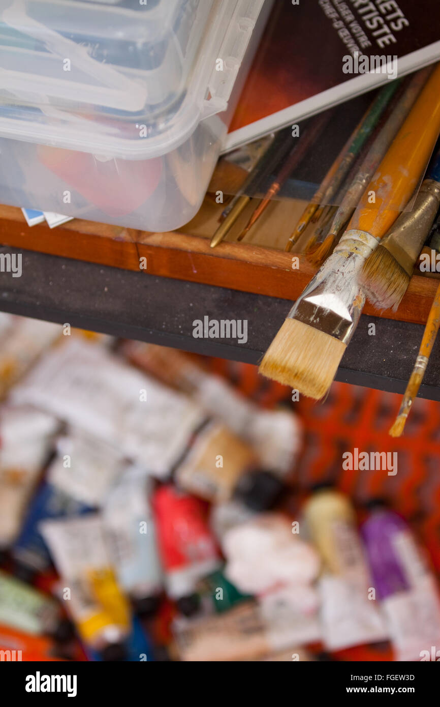 Artists brushes and paint container Stock Photo - Alamy