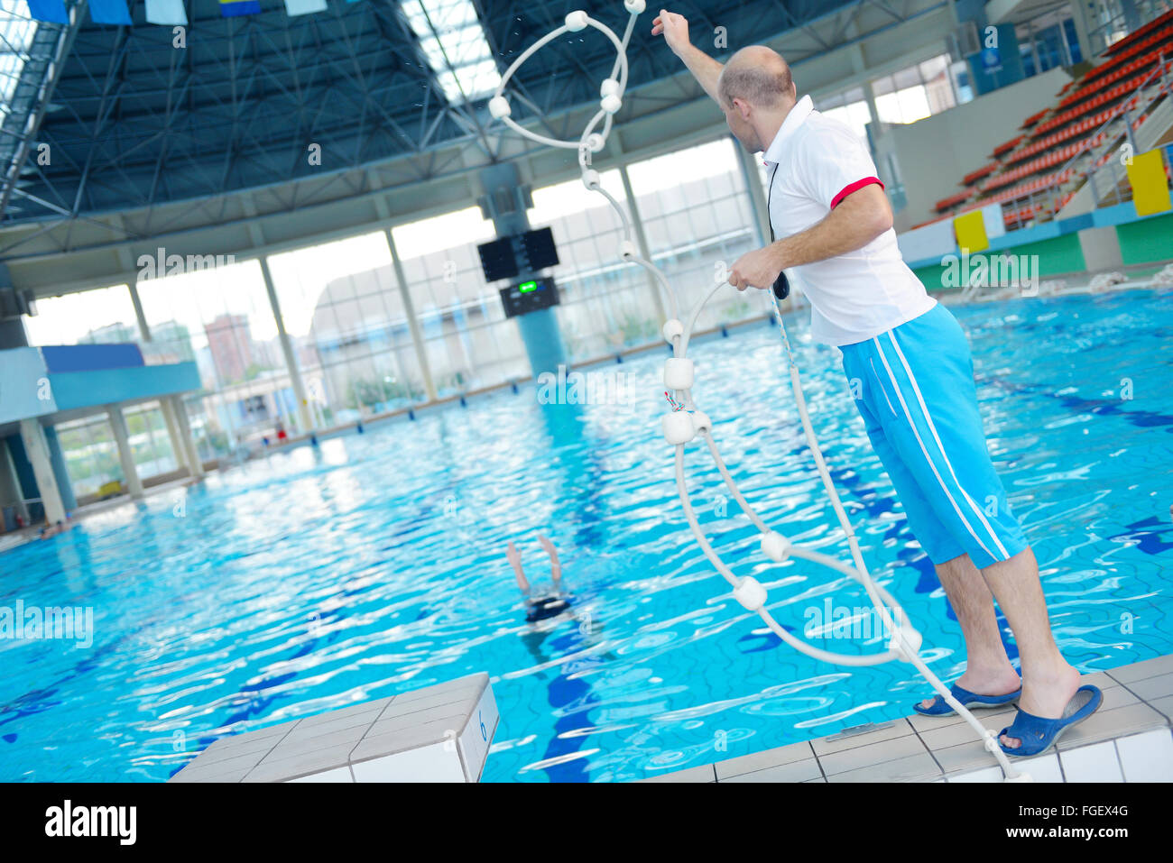 help and rescue on swimming pool Stock Photo - Alamy