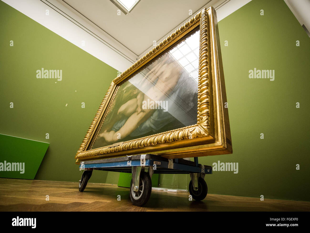 Museum staff are putting up the painting 'Venus and Amor' by Jacopo ...